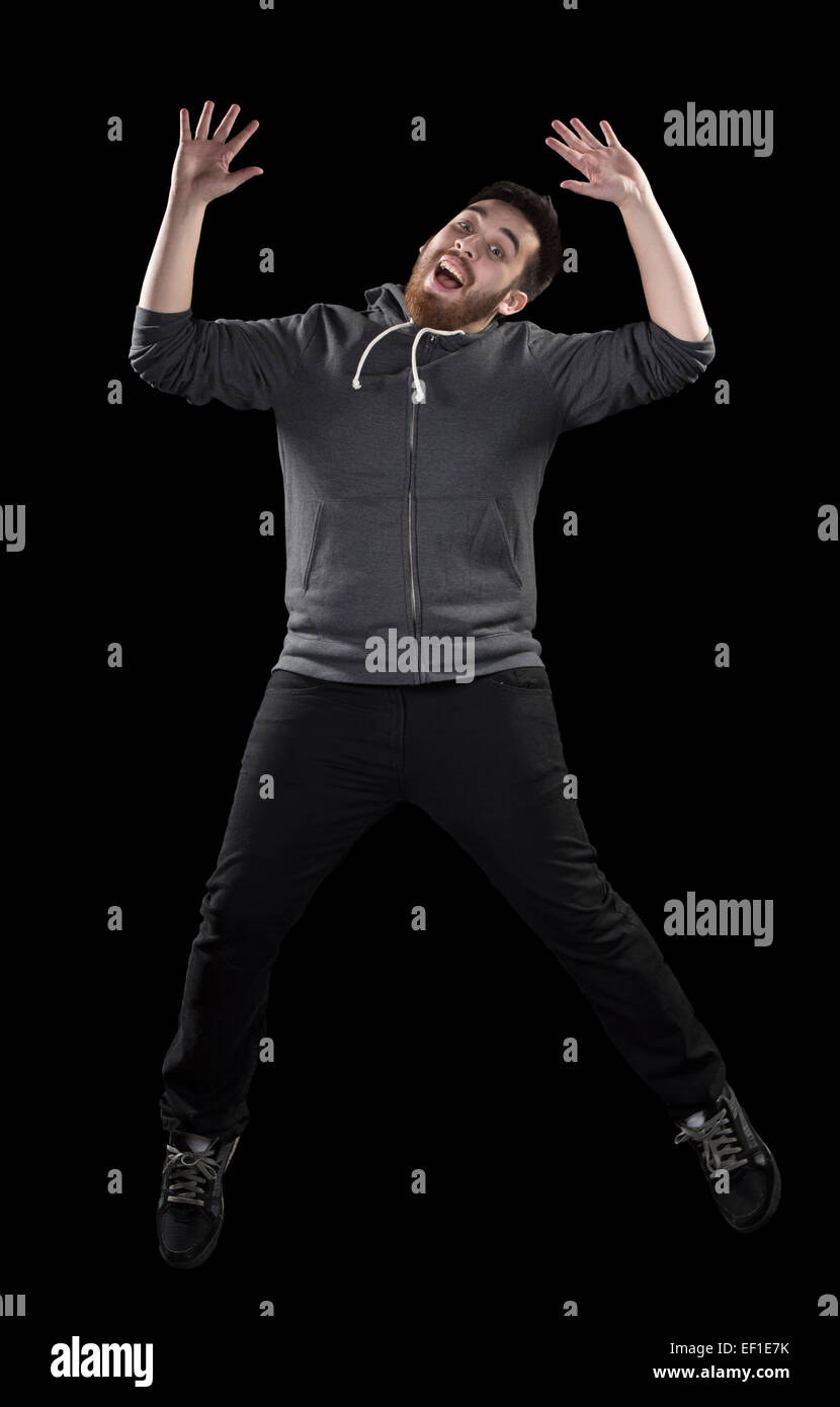 Happy Man in Wacky Pose on Black Background Stock Photo - Alamy