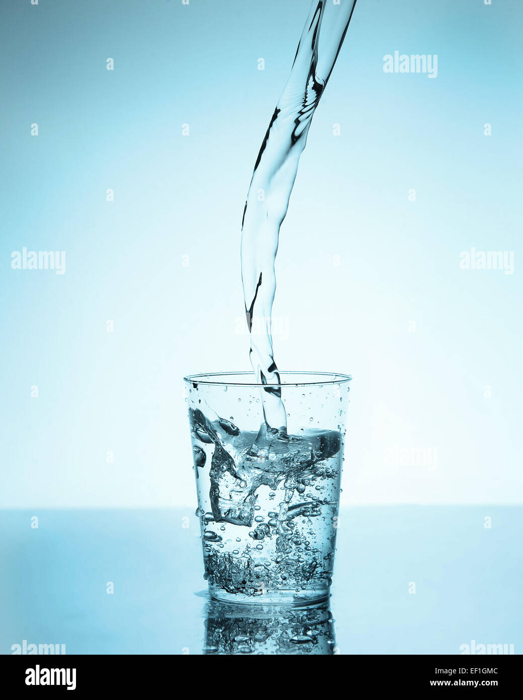 Fresh spring water pouring into a glass Stock Photo - Alamy