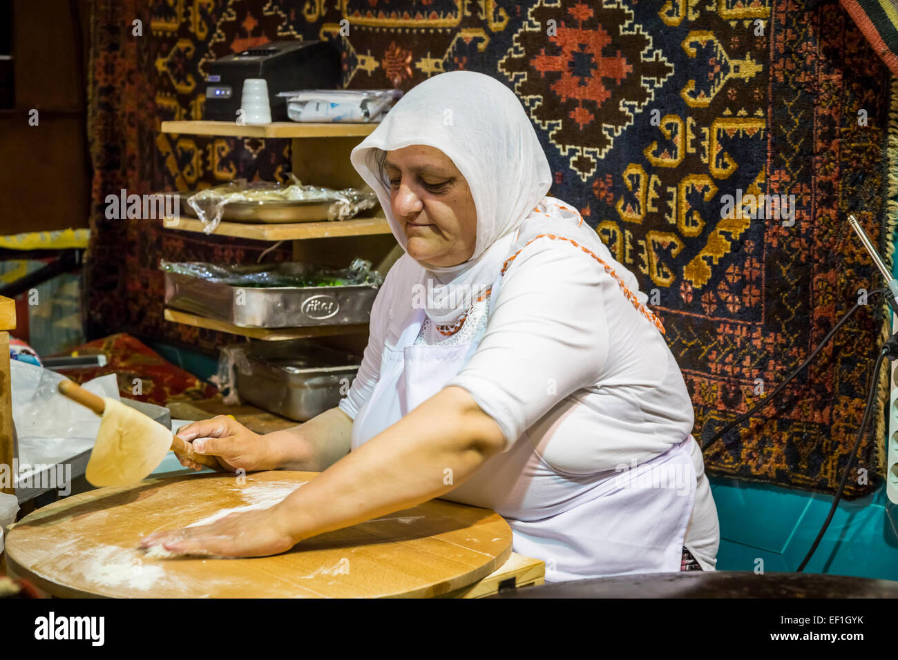 A Turkish woman preparing fresh feta gozleme at a street restaurant in ...