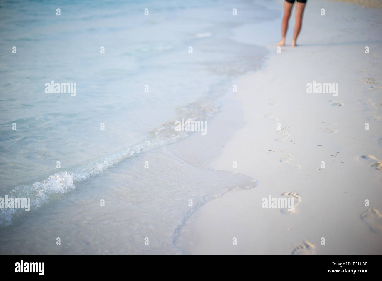Human footprints on white sand beach Stock Photo - Alamy