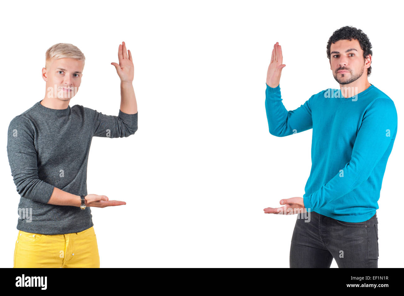 Two handsome men showing something with hands Stock Photo - Alamy