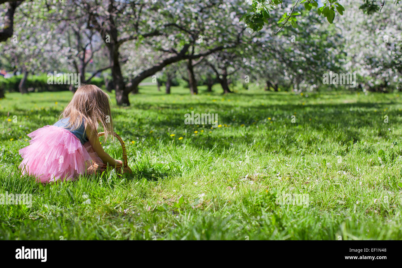 Adorable little girl in blossoming apple garden Stock Photo - Alamy