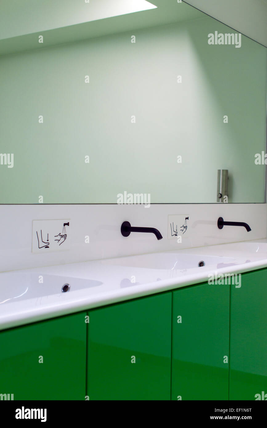 Mirror and faucet in public bathroom Stock Photo - Alamy