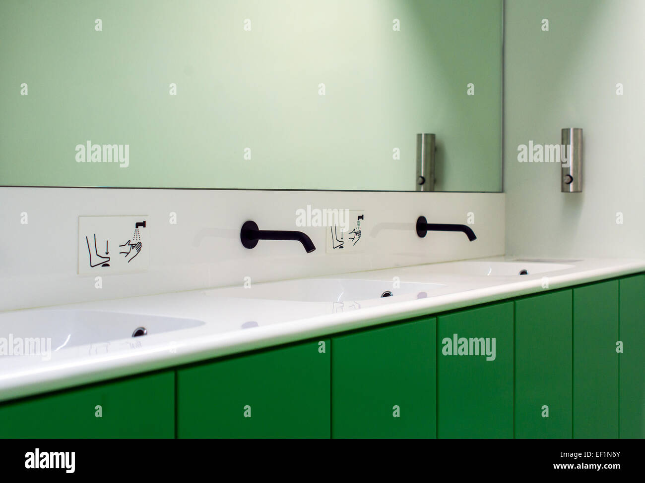 Mirror and faucet in public bathroom Stock Photo - Alamy