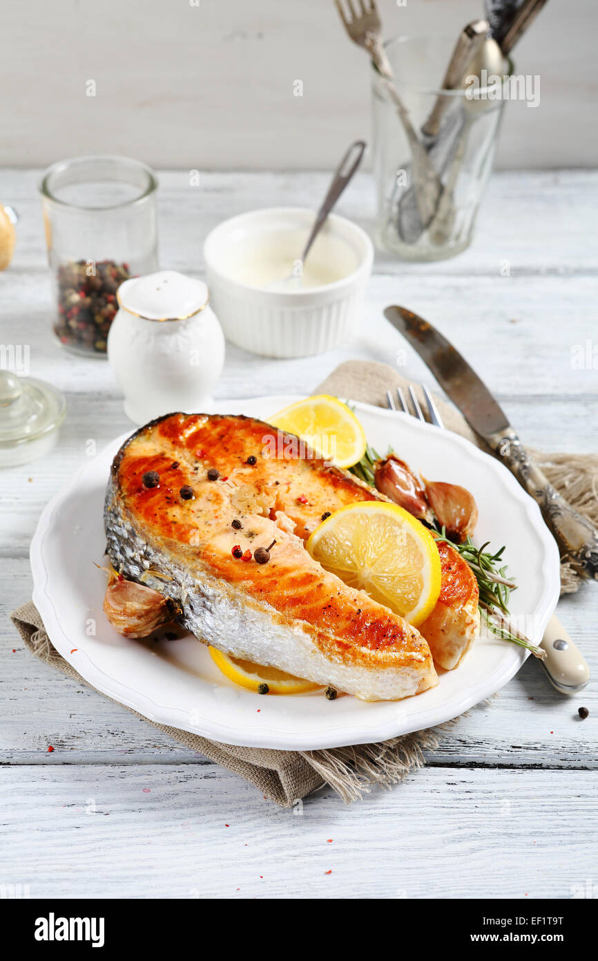 Salmon steak with lemon on a plate, food Stock Photo - Alamy