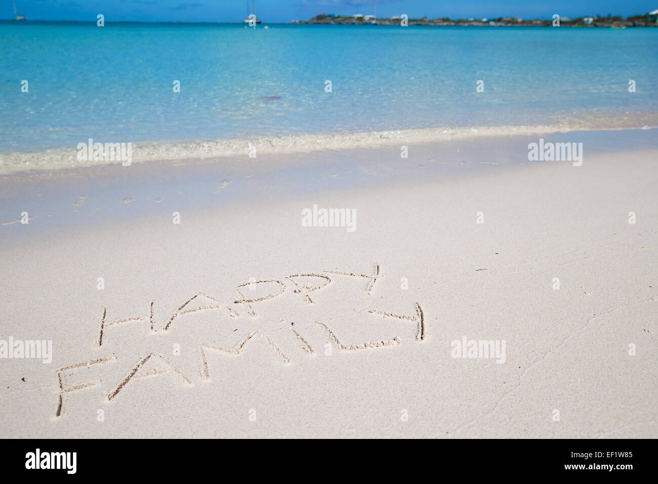Happy family written on tropical beach white sand Stock Photo - Alamy