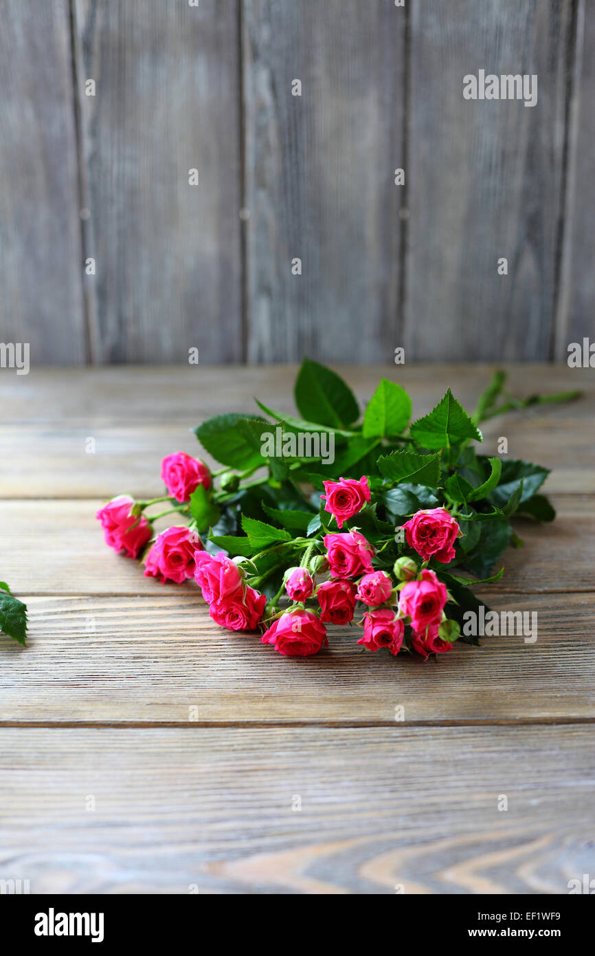 Roses on the boards, flowers Stock Photo - Alamy