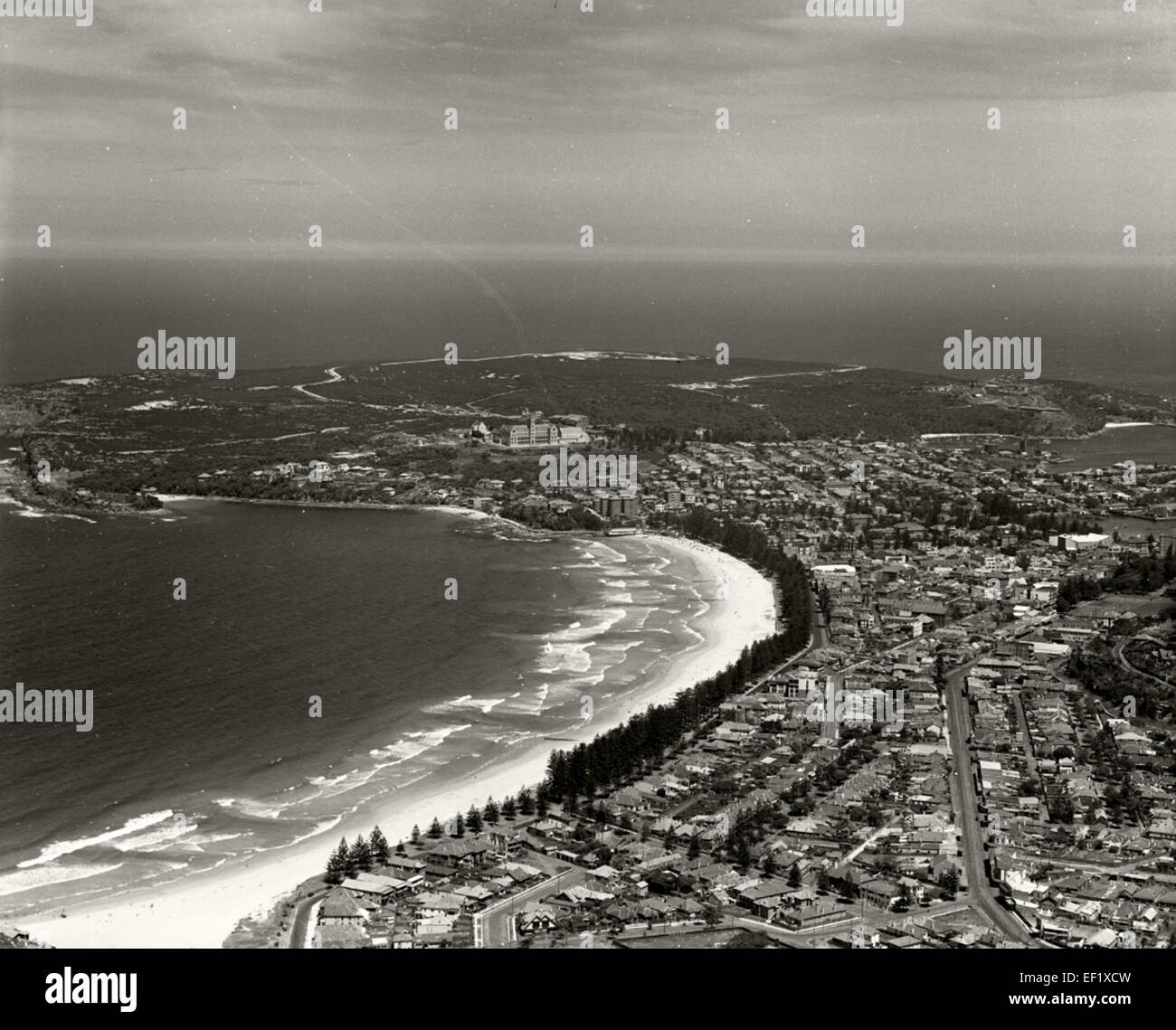 A historical photograph of Manly Ocean Beach, taken in 1937, showing a ...