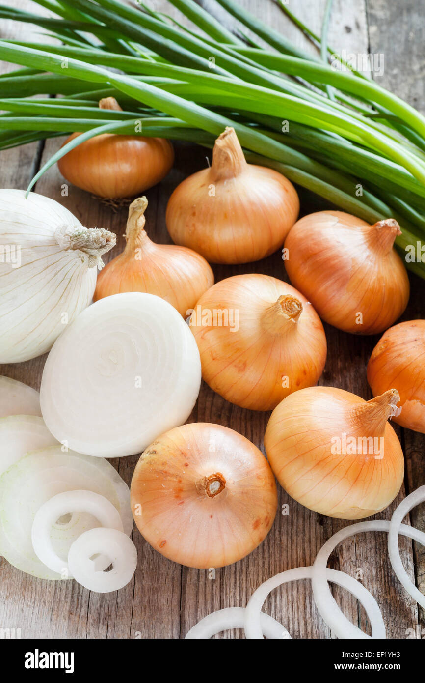 different onions on wooden rustic table Stock Photo - Alamy