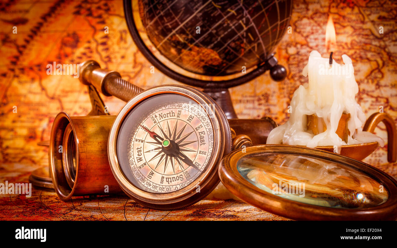 Vintage still life. Vintage magnifying glass lies on an ancient world ...