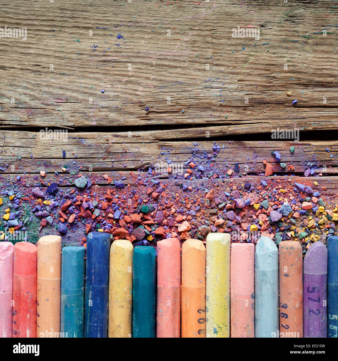 Artistic pastel crayons and pigment dust on old rustic wooden ...