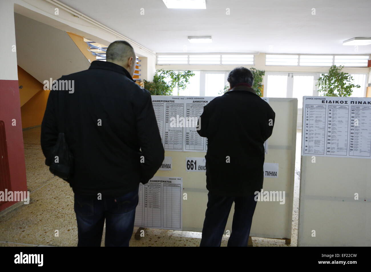 Athens, Greece. 25th January 2015. Two voters look at the voting lists ...