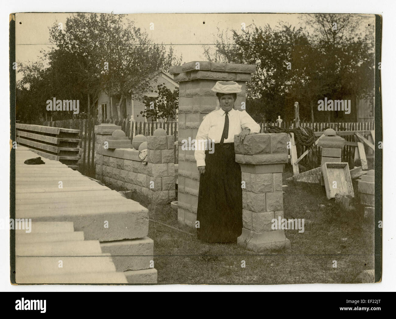 Mrs. E. M. Barrett is pictured working in her concrete block yard in ...