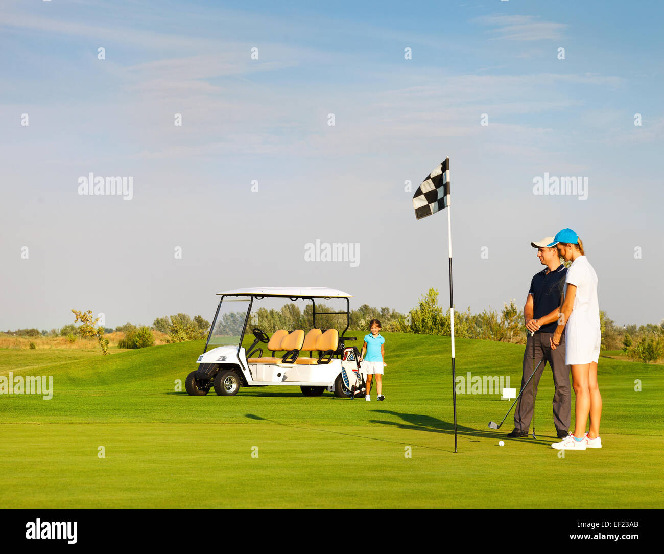Sportive happy family playing golf on a golf course Stock Photo - Alamy