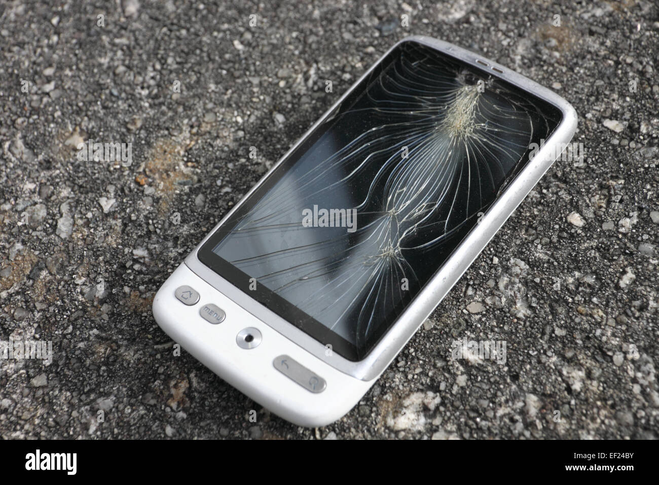 A white HTC 'phone with a smashed touchscreen on concrete Stock Photo ...