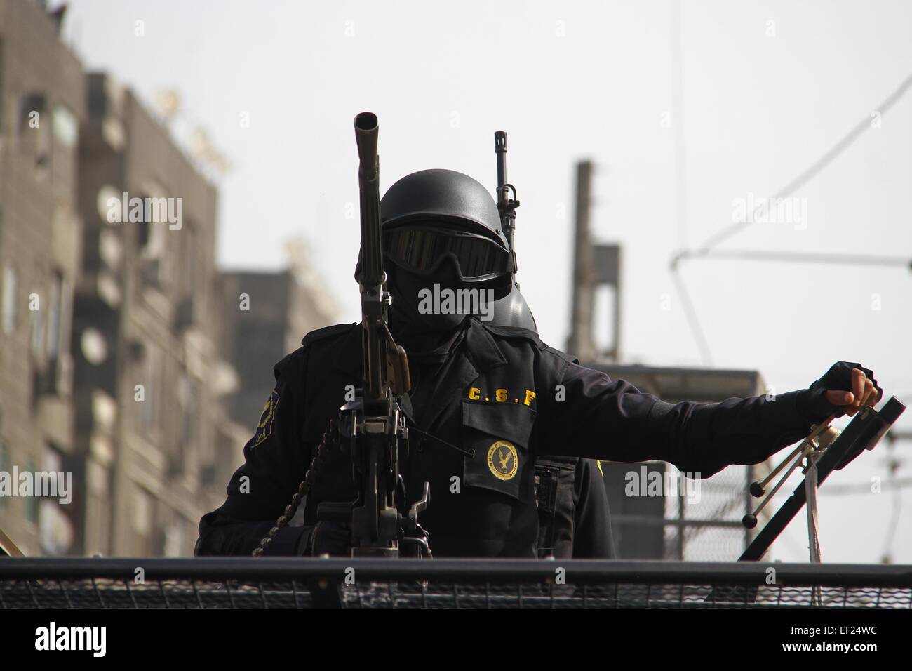 Cairo. 25th Jan, 2015. A riot police stands guard in the district of Al ...