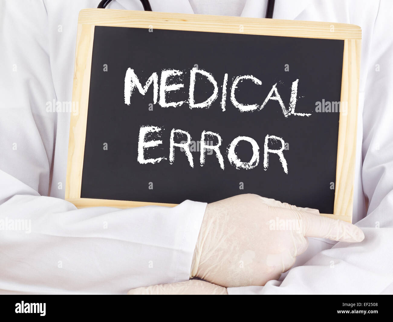 Doctor shows information on blackboard: medical error Stock Photo - Alamy