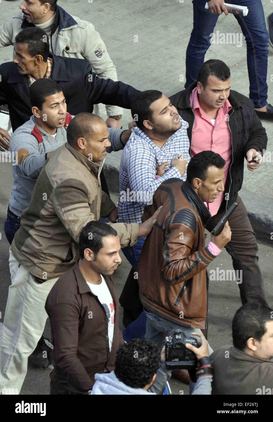 Cairo, Egypt. 25th Jan, 2015. An Egyptian is arrested by plainclothes ...