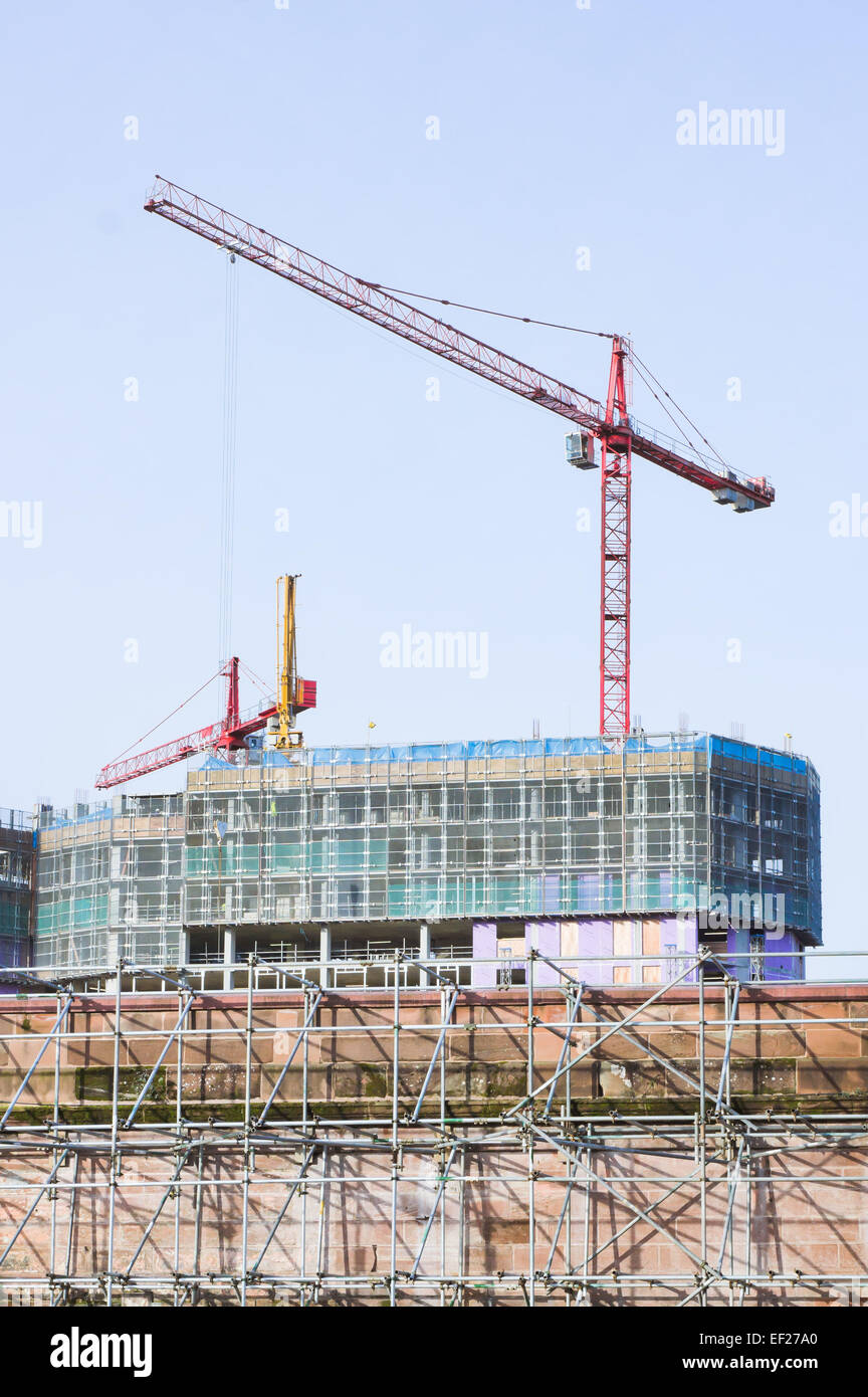 A crane and scaffolding at a construction site Stock Photo - Alamy
