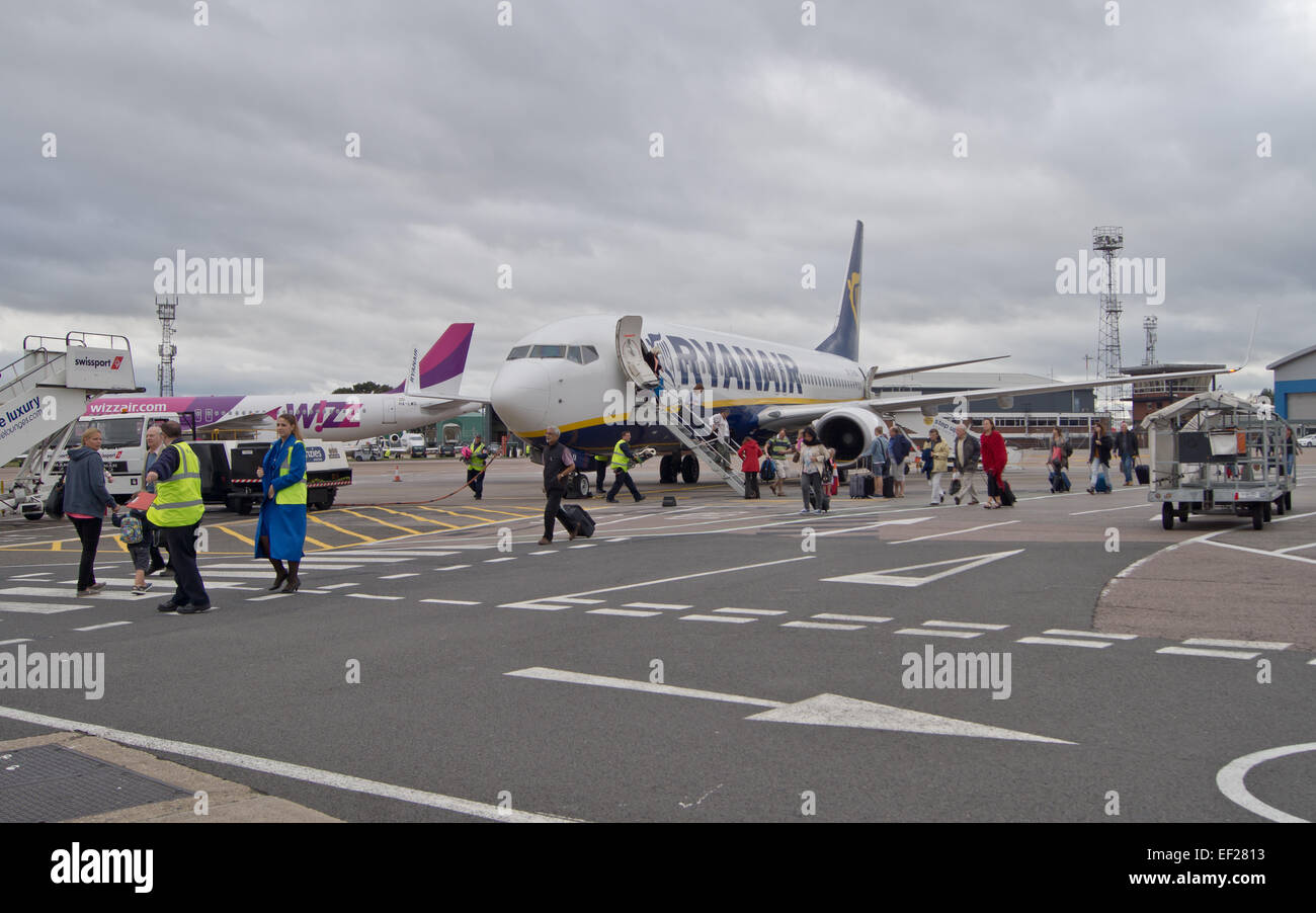 Passengers disembark a Ryanair plane from Luton airport Stock Photo - Alamy