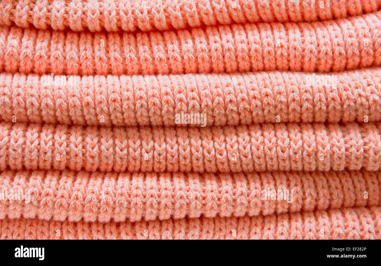 Pile of folded orange wool jumpers Stock Photo - Alamy