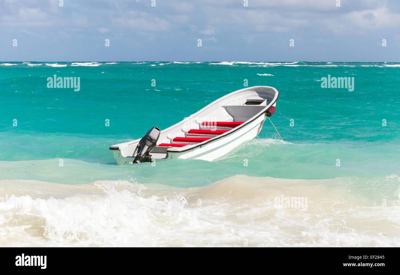 White pleasure boat floats on stormy waves. Dominican republic. Coast ...