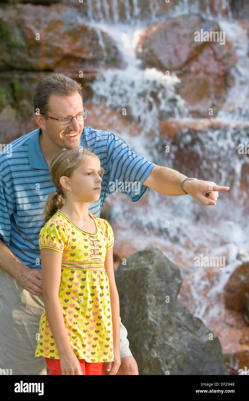 Father and daughter by a waterfall Stock Photo - Alamy