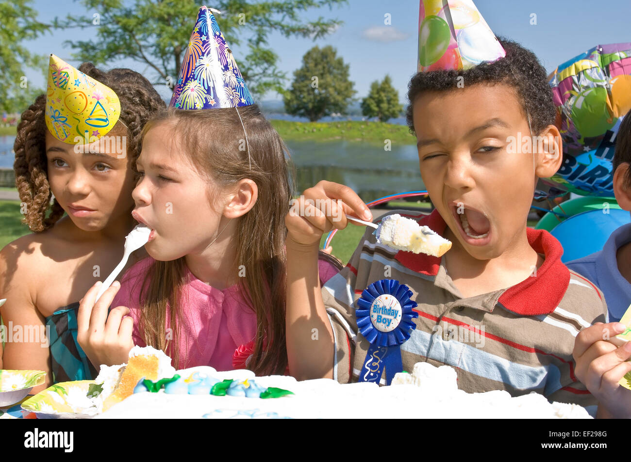 Children eating birthday cake Stock Photo - Alamy
