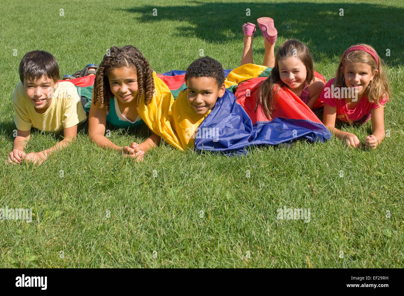 Children playing with a parachute Stock Photo - Alamy