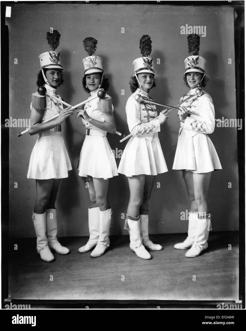 The photograph features unidentified drum majorettes performing in a ...