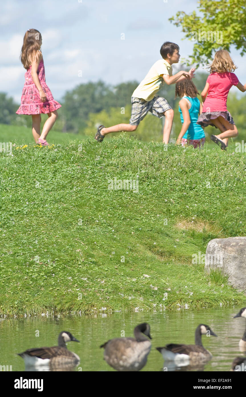 Children running in the park Stock Photo - Alamy