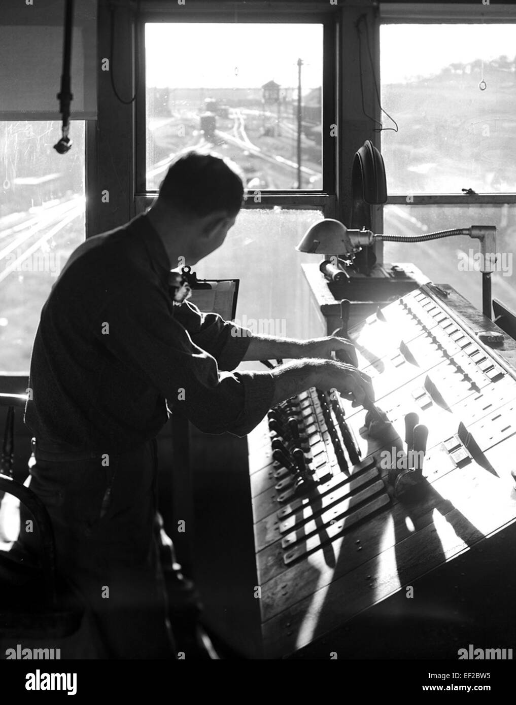 A car-retarder operator in a retarder shack at the Texas & Pacific ...