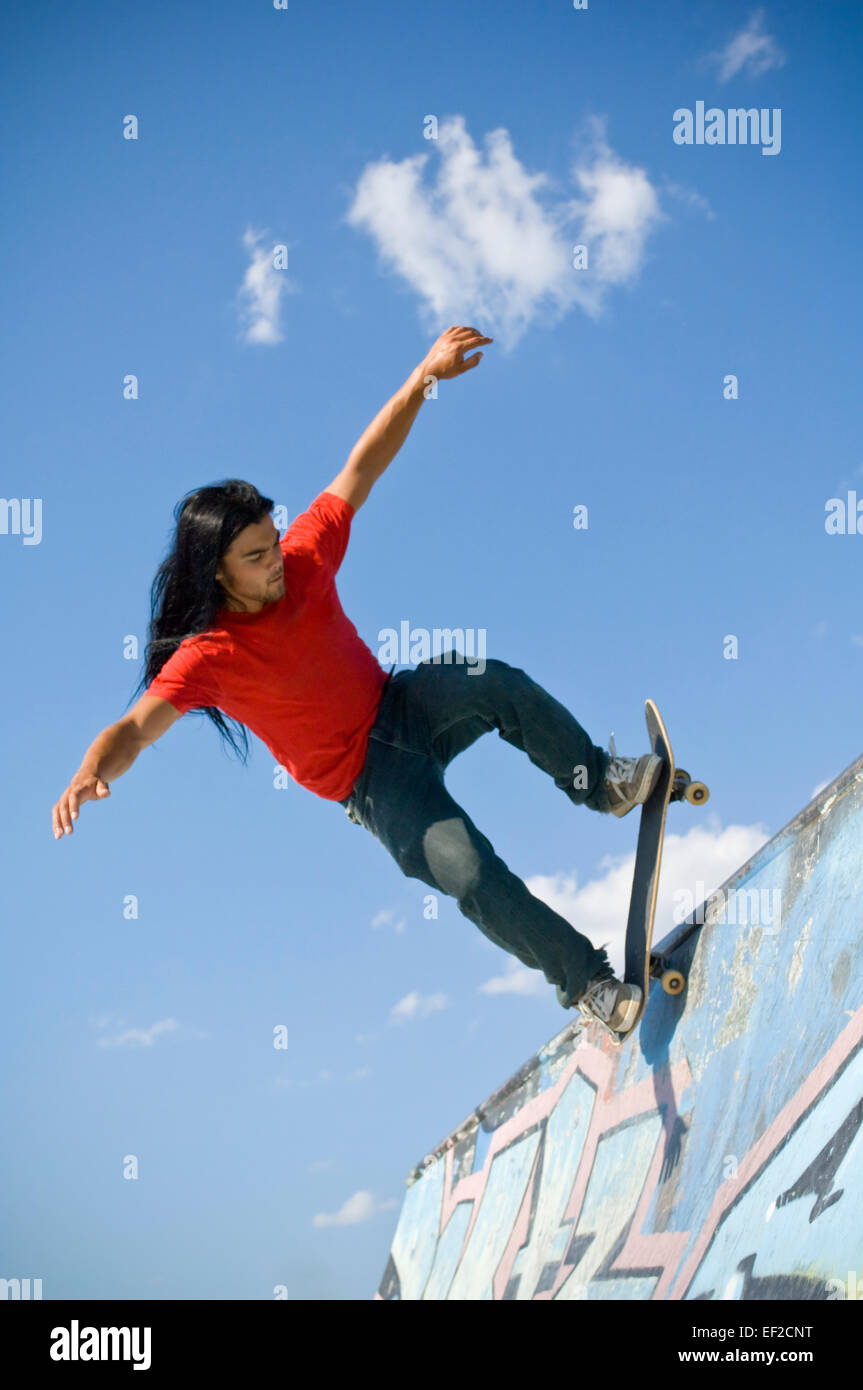 A young man skateboarding on a skateboard ramp Stock Photo - Alamy
