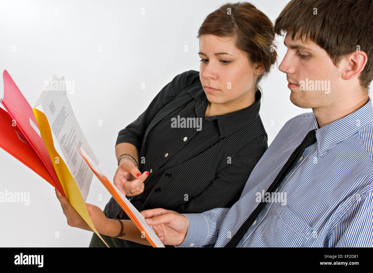 Couple looking at paperwork Stock Photo - Alamy