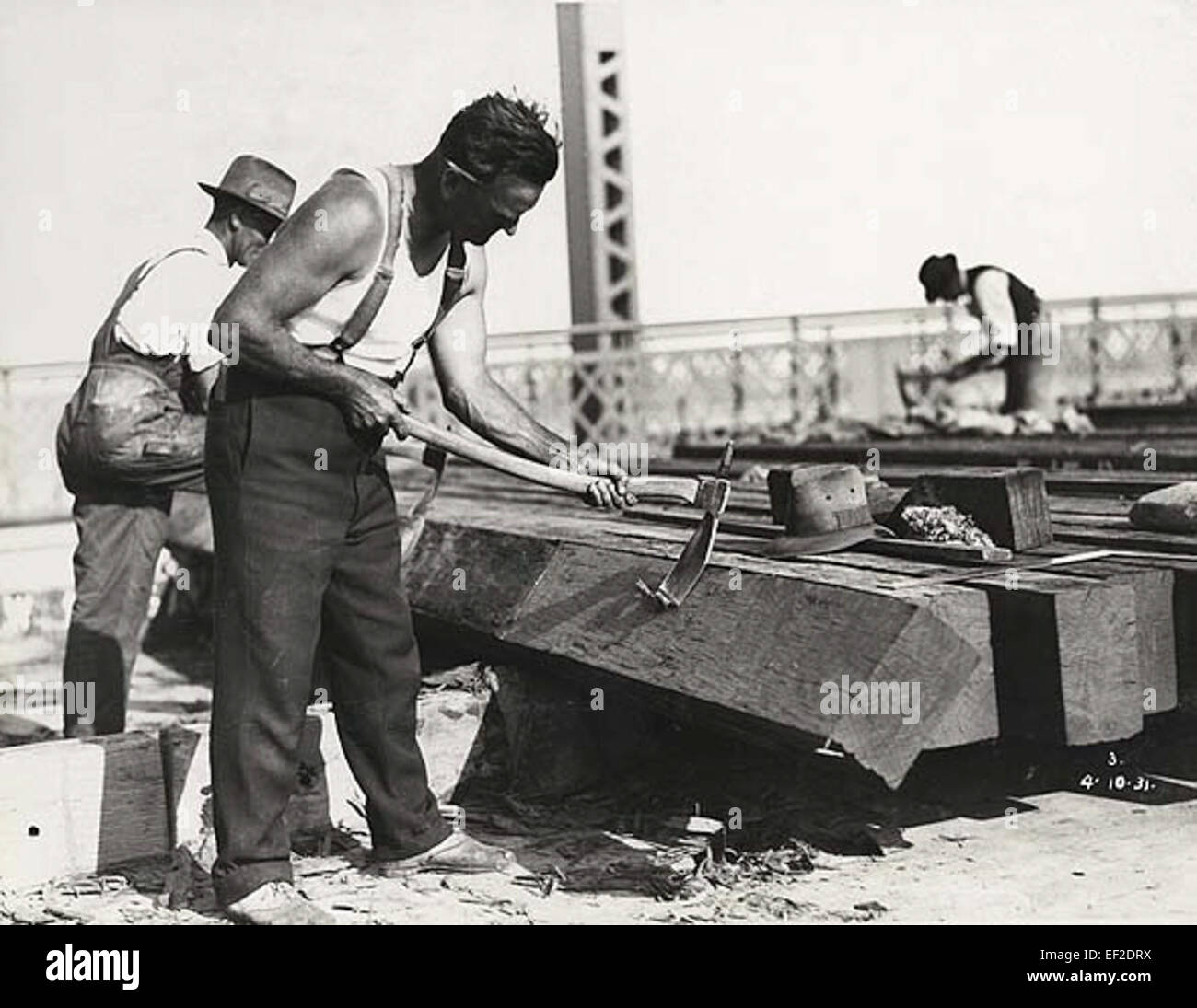 Workers prepare iron bark track timbers for the Sydney Harbour Bridge ...