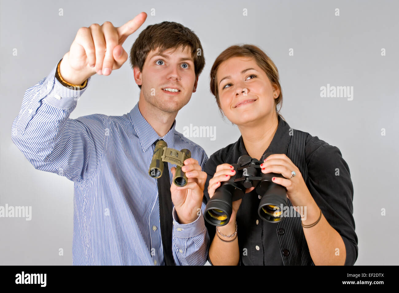 Couple holding binoculars Stock Photo - Alamy
