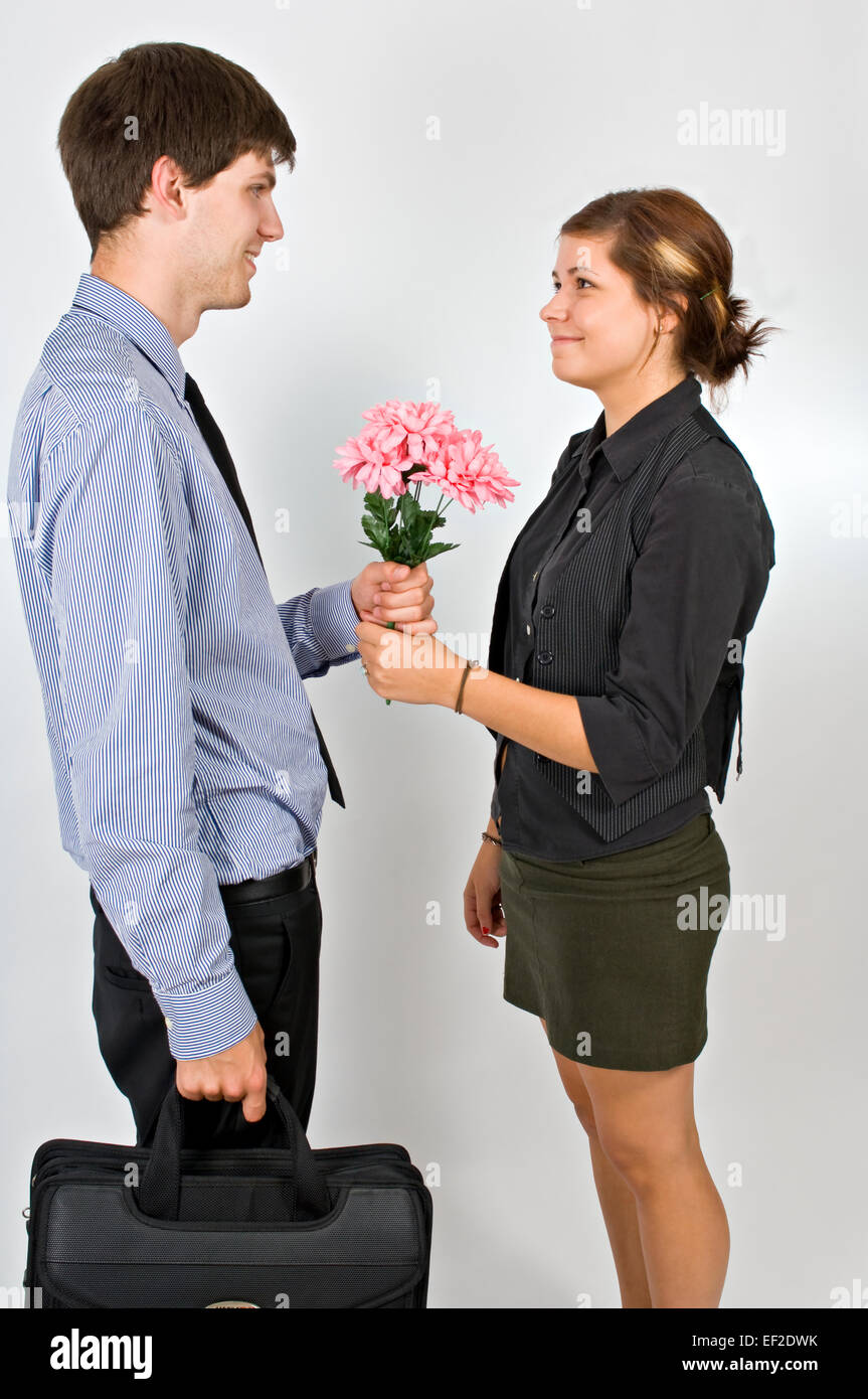 Young man giving flowers to young woman Stock Photo - Alamy