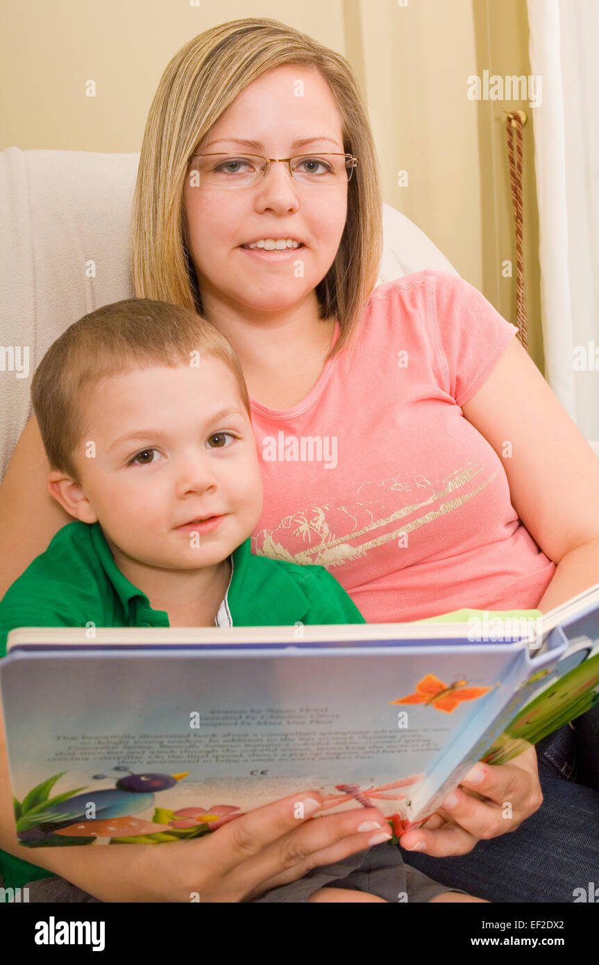 Mother reading a book to her young son Stock Photo - Alamy