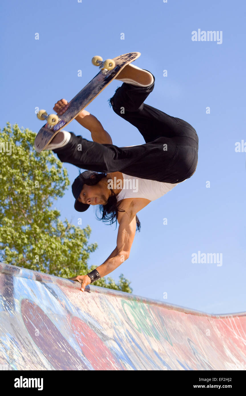 Skateboarder doing aerials at a skate park Stock Photo - Alamy