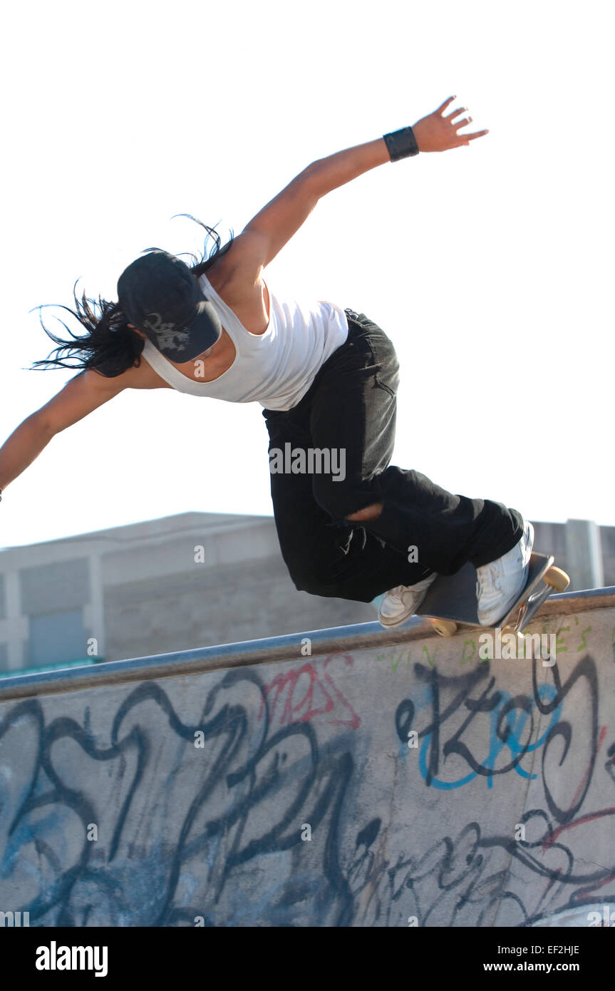Skateboarder grinding a rail at a skate park Stock Photo - Alamy