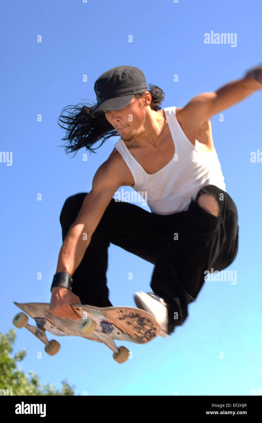 Skateboarder doing an aerial Stock Photo - Alamy