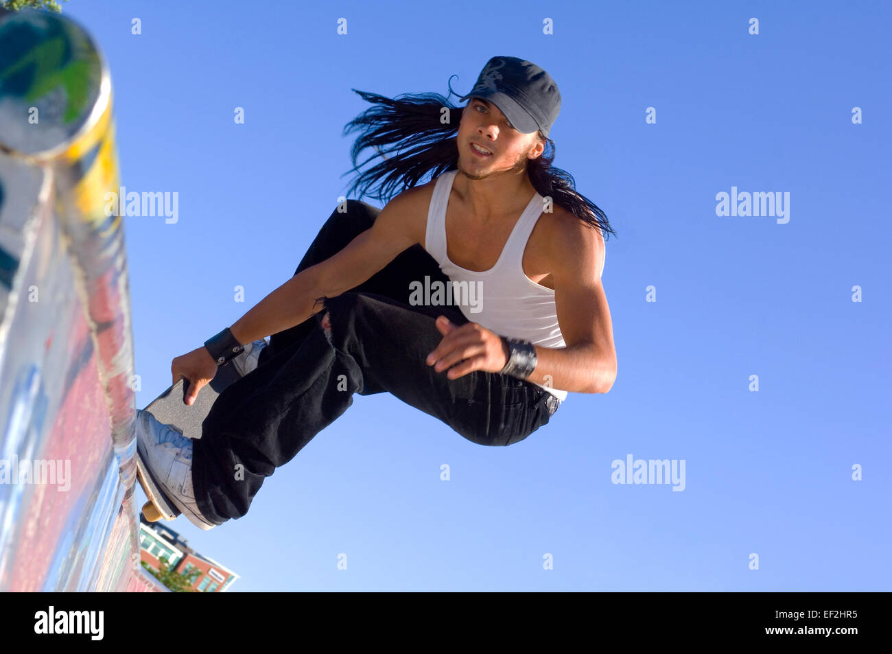 Skateboarder grinding a rail at a skate park Stock Photo - Alamy