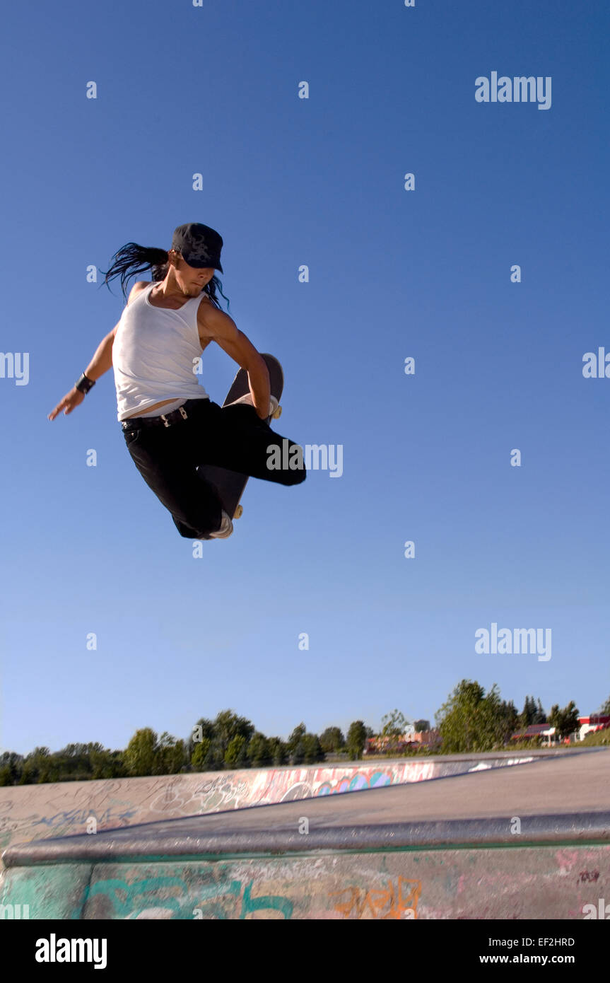 Skateboarder doing aerials at a skate park Stock Photo - Alamy