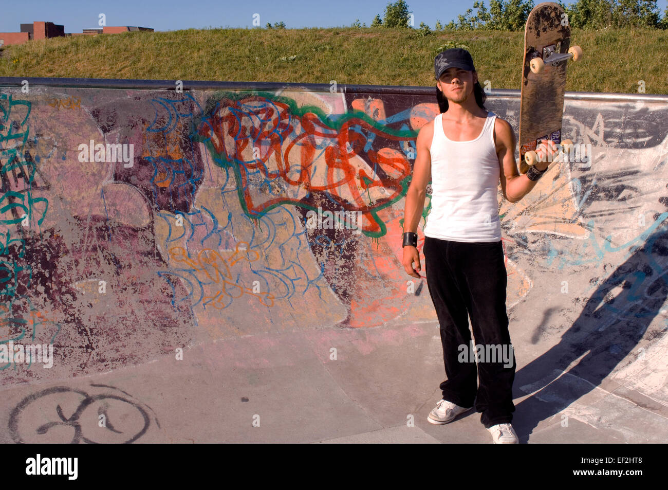 Skateboarder hanging around at a skate park Stock Photo - Alamy