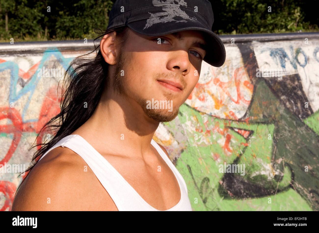 Skateboarder hanging around at a skate park Stock Photo - Alamy