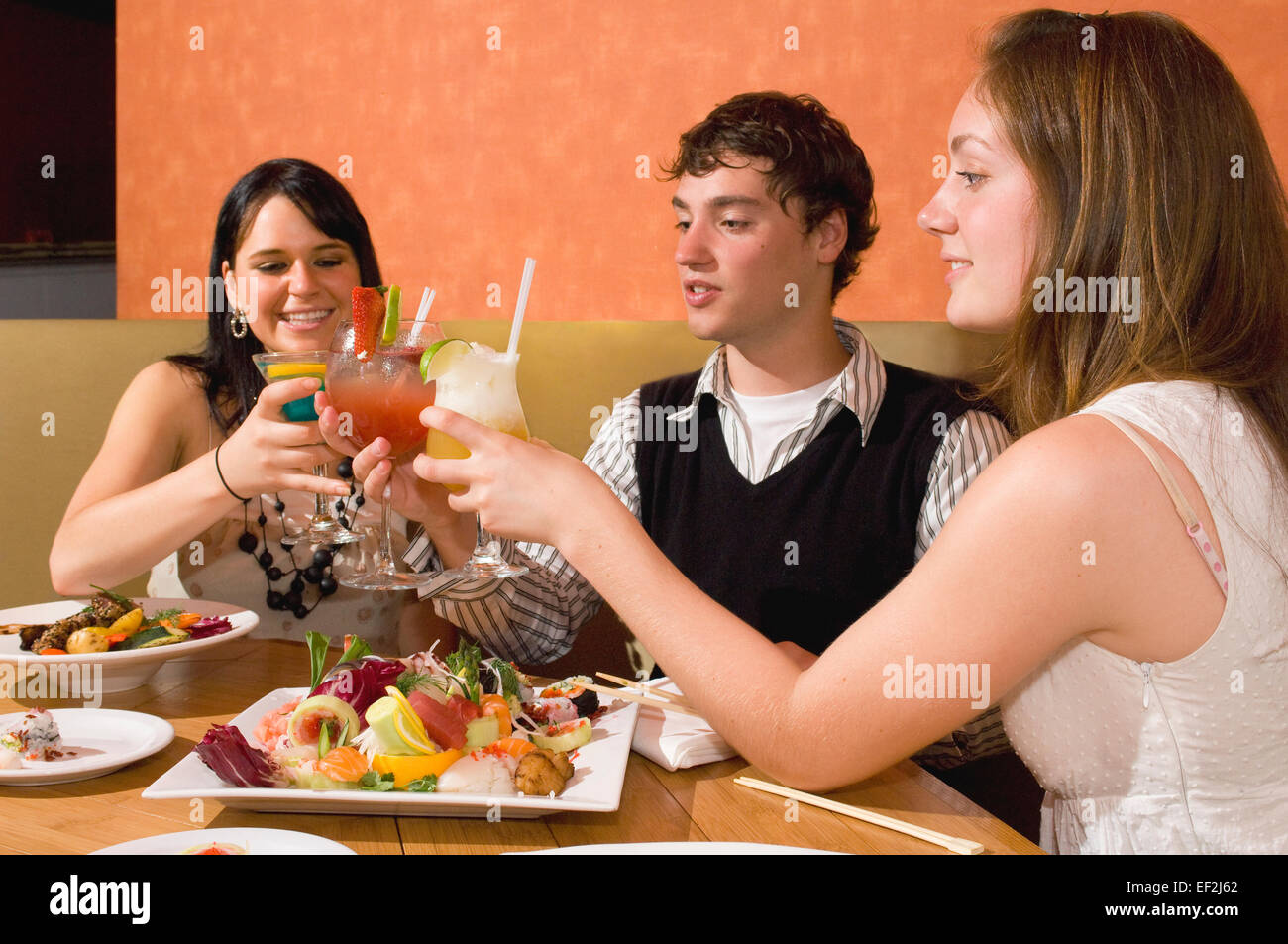 Three friends at a sushi restaurant Stock Photo - Alamy