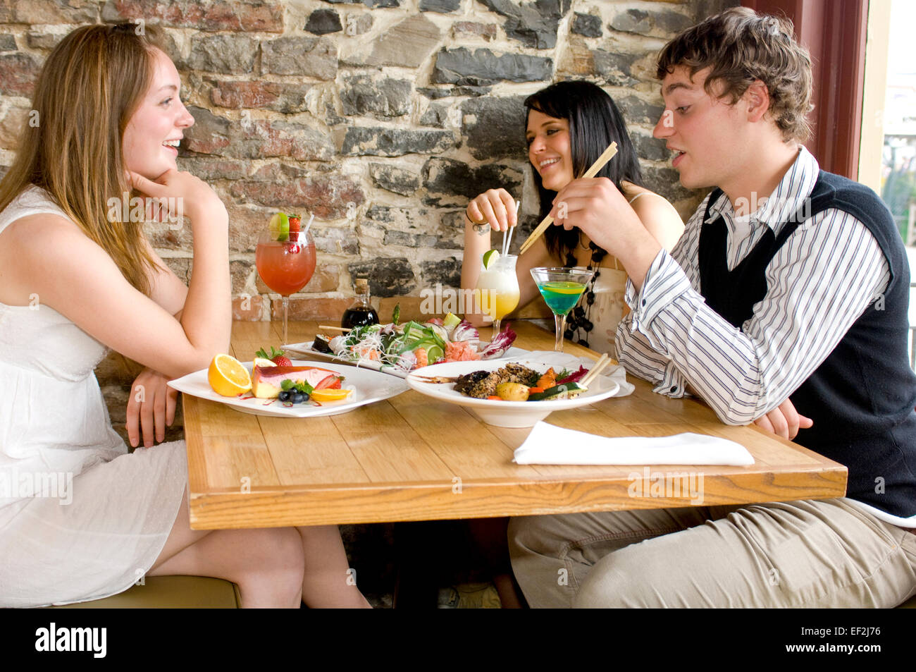 Three friends at a sushi restaurant Stock Photo - Alamy