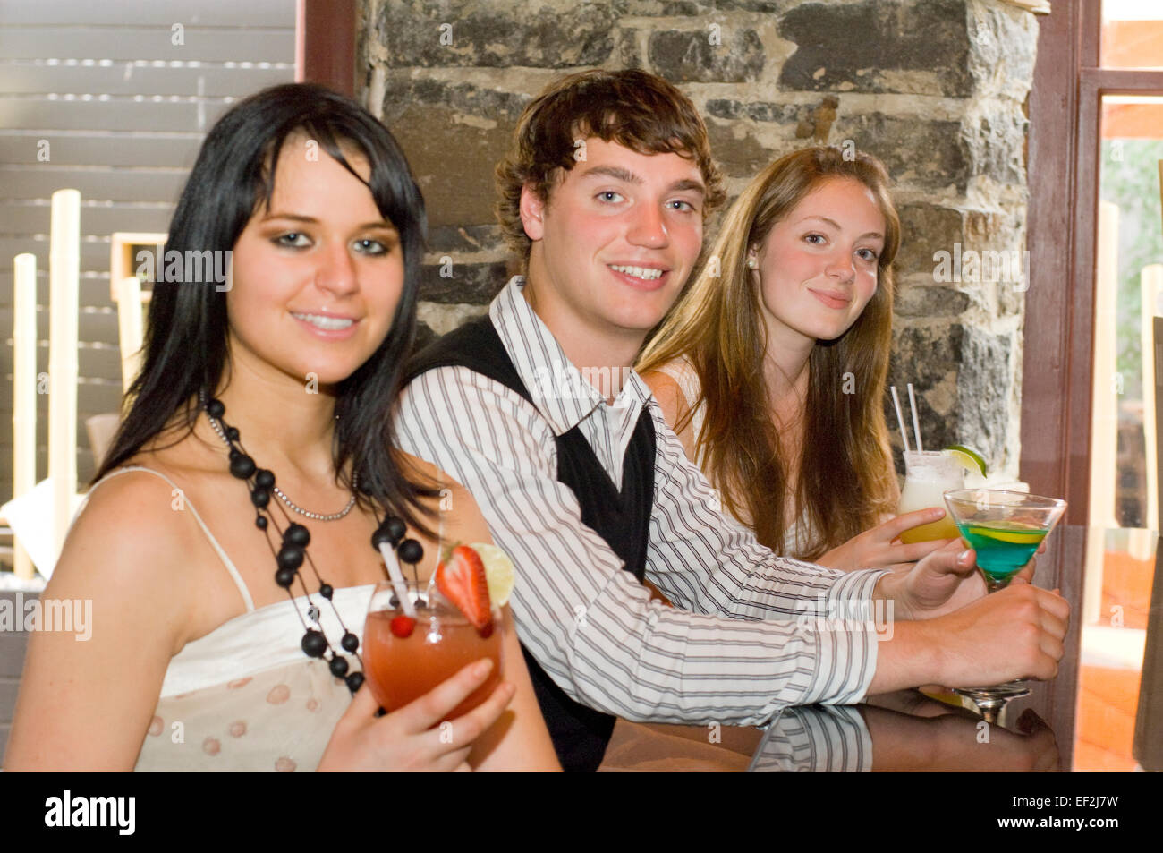 Three people at a bar in a sushi restaurant Stock Photo - Alamy