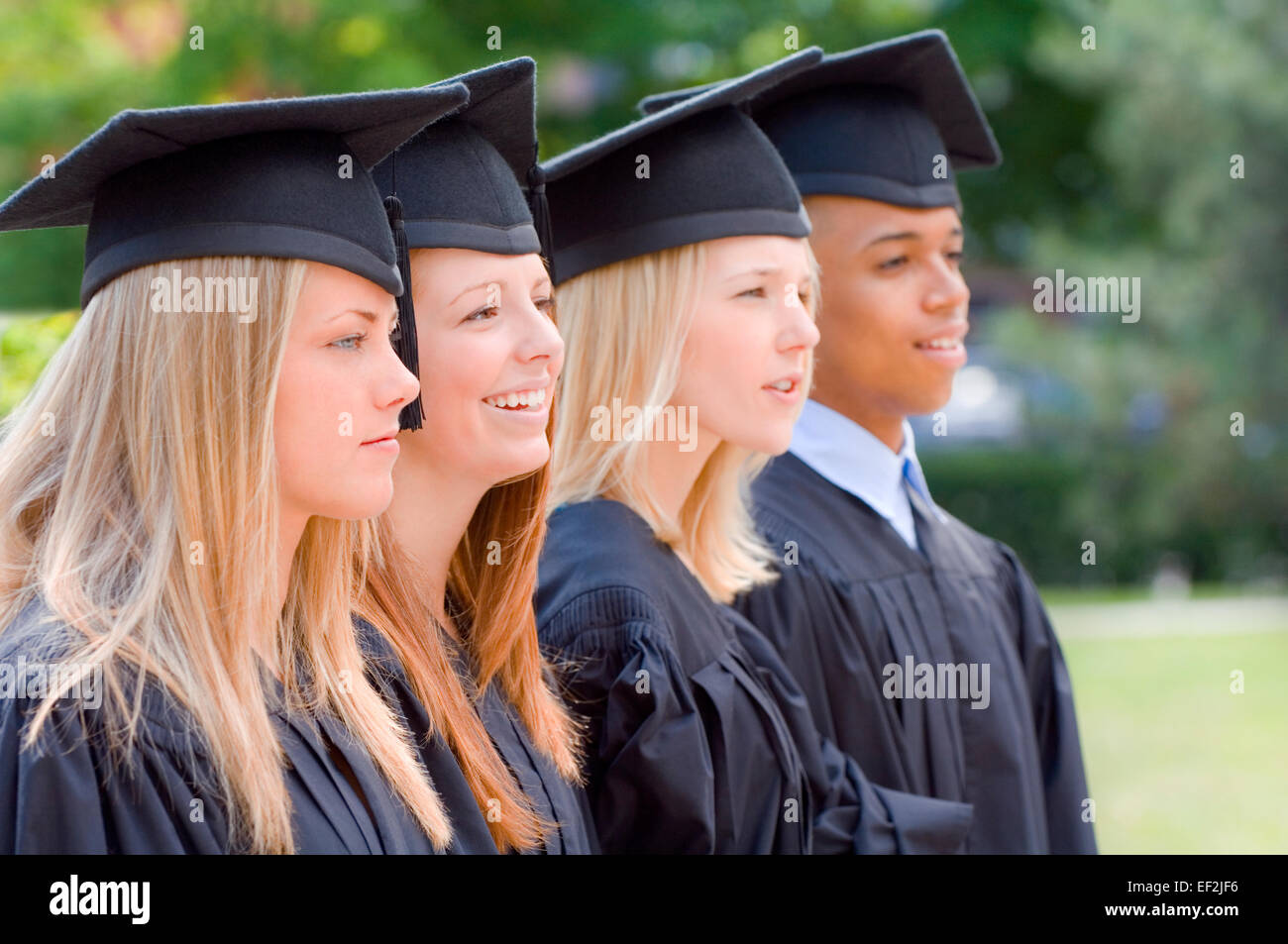 Four friends at graduation ceremony Stock Photo - Alamy