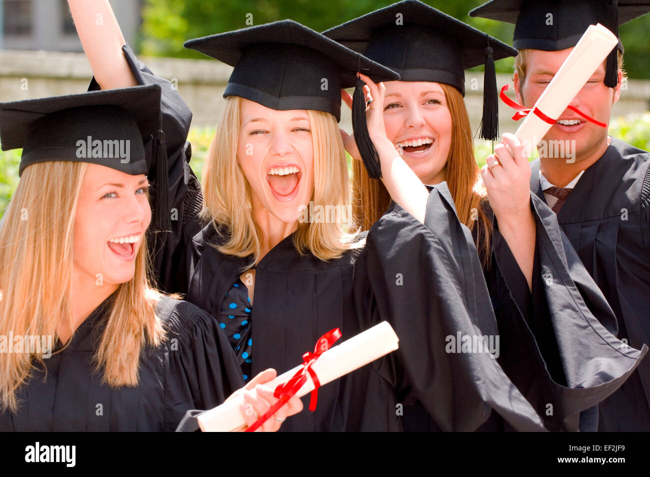 Four friends at graduation ceremony Stock Photo - Alamy